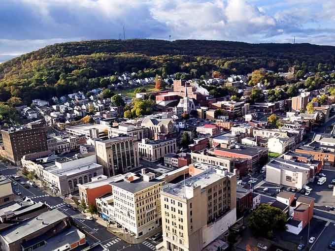 Aerial perspective reveals how mountains cradle this affordable gem, making "room with a view" actually financially possible.