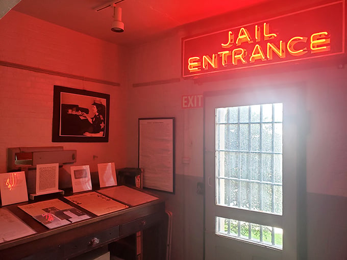 The red glow of the entrance sign sets an appropriately dramatic mood for your journey into history.