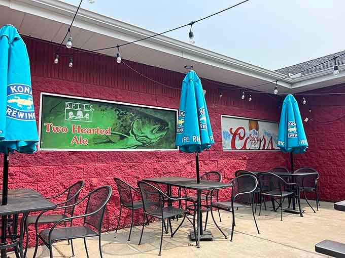 Outdoor seating with beer signs and string lights, because sometimes the best dining room has no roof at all.