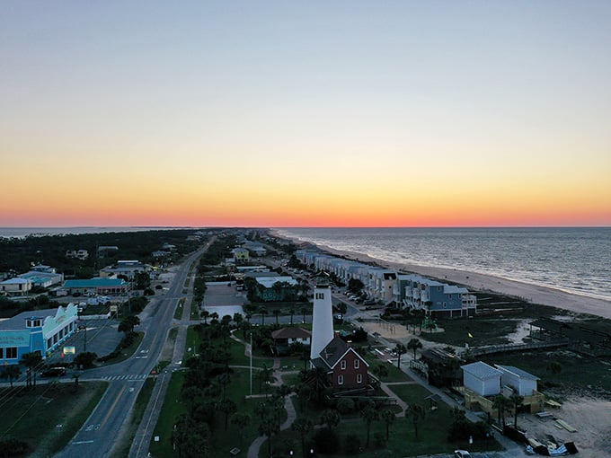 The lighthouse stands sentinel as another perfect day melts into the Gulf horizon.
