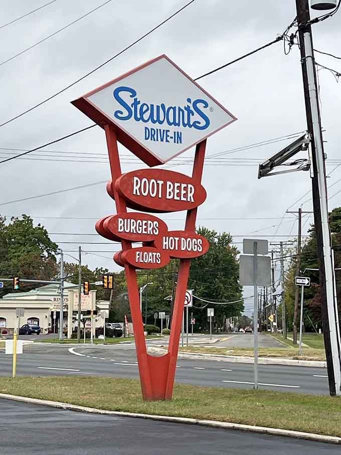 The vintage signage stands tall, advertising root beer, burgers, and hot dogs with the confidence of 75+ years' experience.