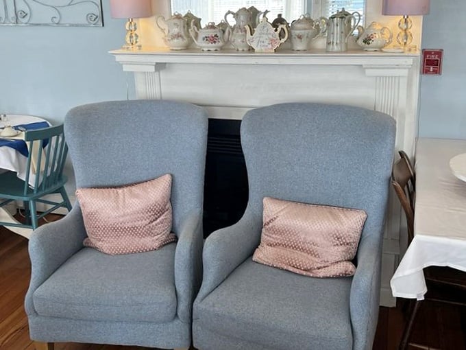 Two wingback chairs flanking a fireplace mantel topped with teapots create the ultimate photo opportunity spot.
