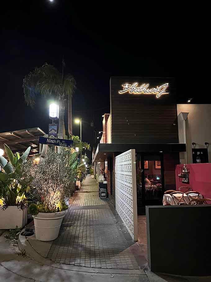 The illuminated sign beckons like a beacon for hungry souls seeking the perfect steak in Manhattan Beach.