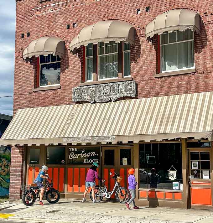 The welcoming storefront on a sunny day, where locals and visitors alike discover that small-town charm and world-class pizza coexist beautifully.