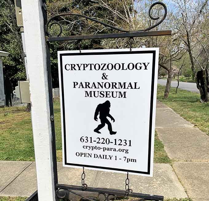 The simple black-and-white sign announces daily hours for exploring the unexplained, because mysteries don't keep banker's hours around here.