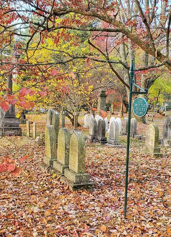 Historic family plots nestle beneath fall's colorful canopy, where past and present coexist in natural harmony.