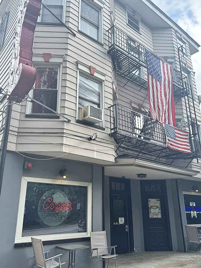The building's classic facade with American flags flying proudly shows that patriotism and Gothic vibes make surprisingly good neighbors here.