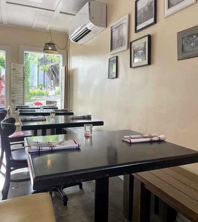 Natural light streaming through the windows illuminates simple tables set and ready&mdash;the calm before the delicious storm of dinner service begins.