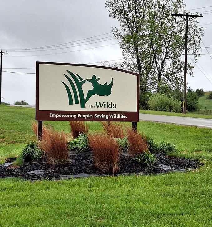 The entrance sign's mission statement reminds visitors that conservation work and incredible experiences can absolutely coexist beautifully here.