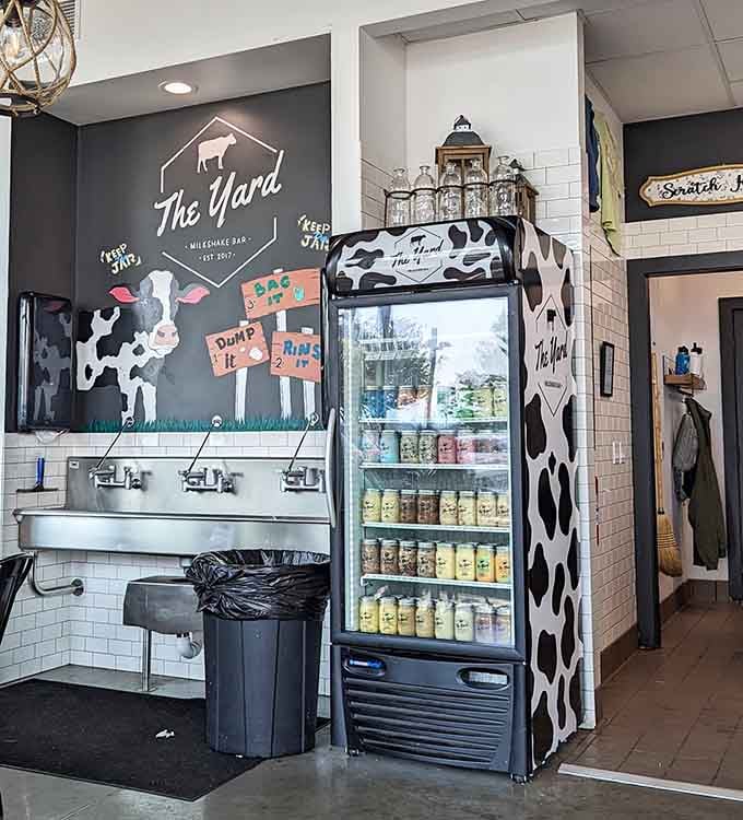 A cow-print fridge stocked with jarred shakes and a cheerful chalkboard wall remind you this place never takes itself too seriously.
