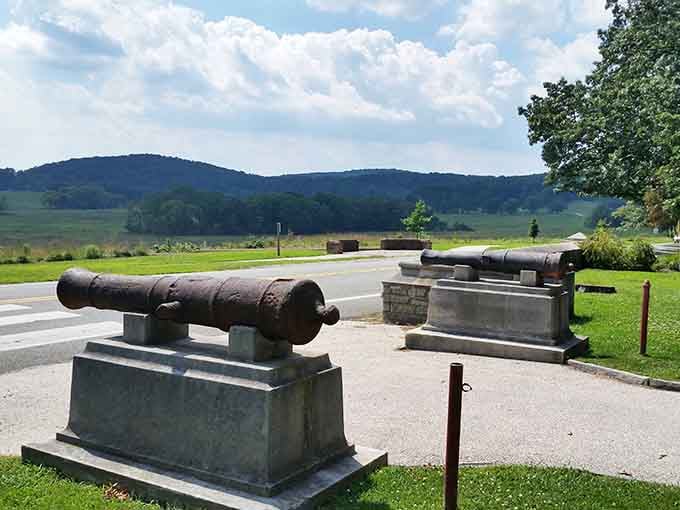 Historic cannons point toward rolling hills, silent sentinels guarding memories of sacrifice and the birth of independence.