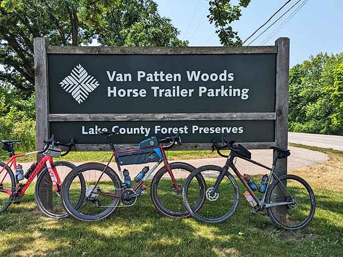Bicycles lean against the sign, their riders already deep into discovering what makes this place special.