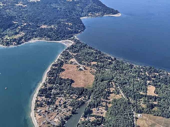 Aerial views reveal the narrow isthmus connecting Vashon to Maury Island, nature's own land bridge masterpiece.