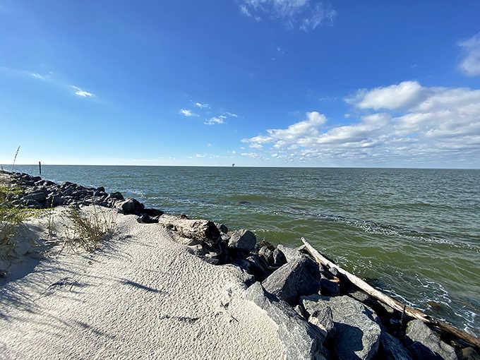 Rocky shoreline meets gentle surf where the island's wild side shows its rugged beauty.