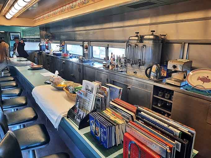 The dining car interior gleams with possibility, where meals were served with silver and scenery came standard.