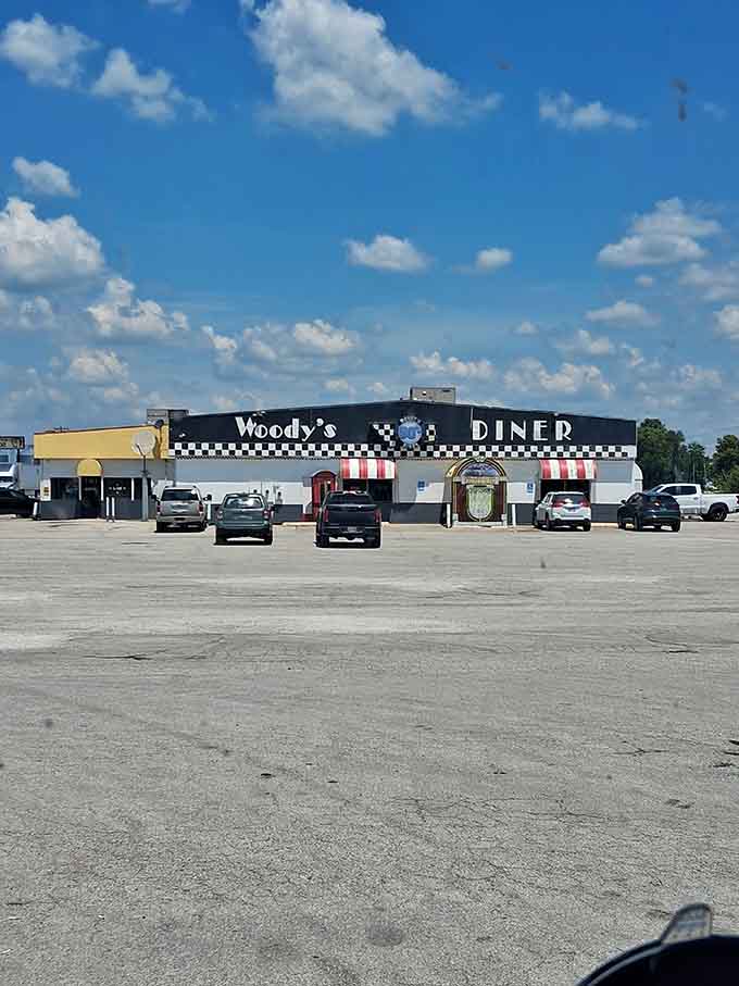 The full exterior shot reveals Woody's commanding presence, a beacon of nostalgia visible from the highway calling hungry travelers home.