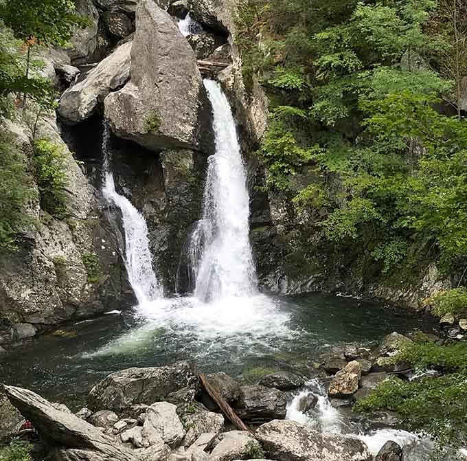 Nature's own double feature: water splits around ancient rock like a perfectly choreographed dance you'll never forget.