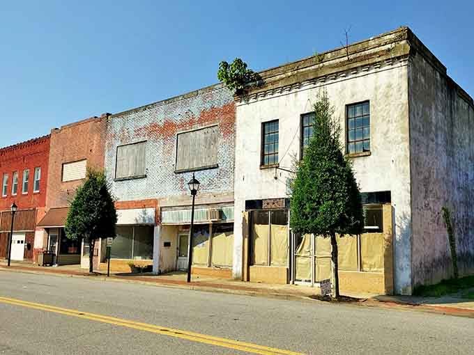 These weathered brick storefronts have stories etched into every crack, standing proud like veterans at a reunion.