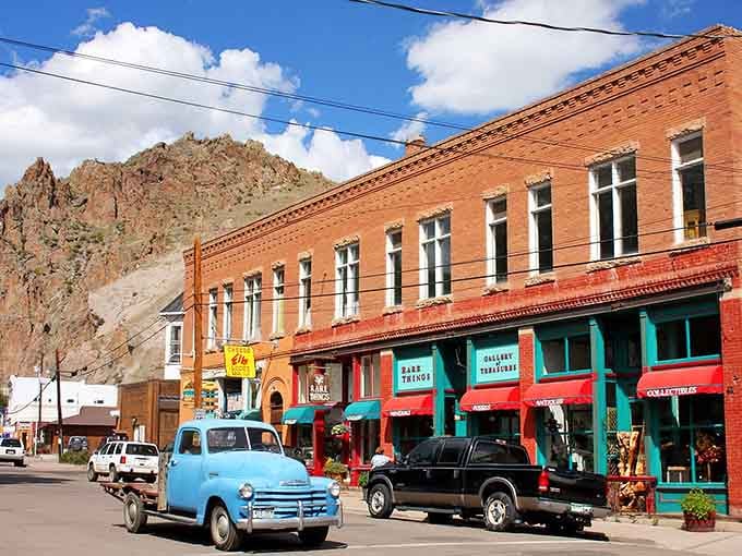 That vintage blue pickup tells you everything about this canyon town where time moves slower and mountains touch clouds.