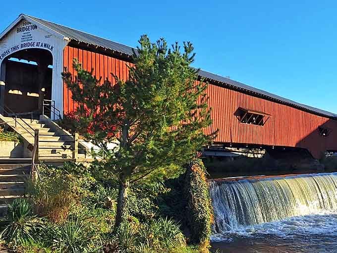That waterfall cascading beside the brilliant red bridge creates a scene straight from a Norman Rockwell painting.