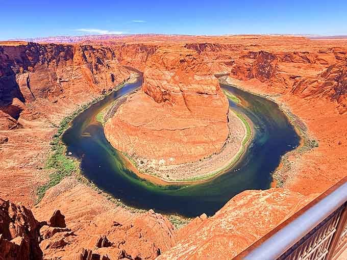 Nature's perfect horseshoe curve where the Colorado River bends in brilliant turquoise against burnt orange cliffs.