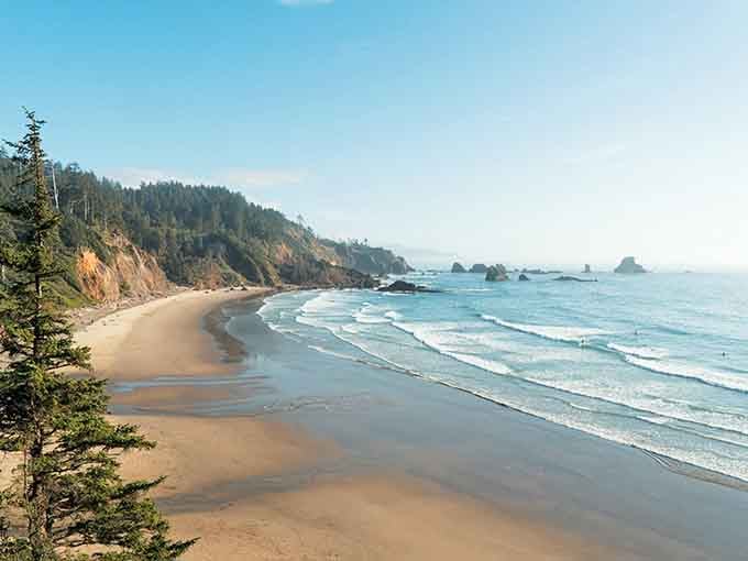This sweeping cove wraps around you like a warm hug, with forested cliffs standing guard over pristine sand.