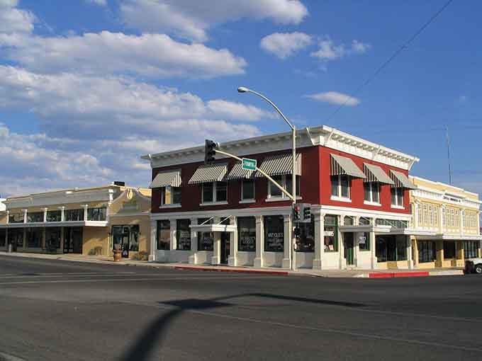 Classic storefronts line this Route 66 town where history meets affordability under endless blue skies.