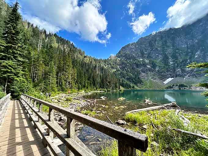 That wooden bridge stretching toward crystal-clear waters proves nature builds better views than any architect ever could.