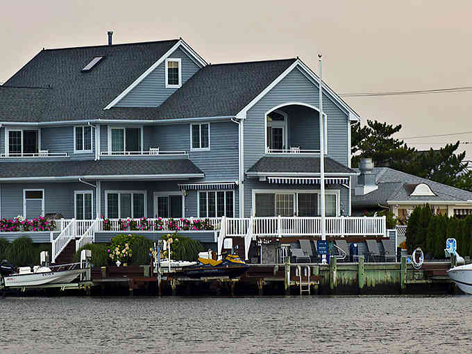 Waterfront living at its finest, where kayaks outnumber cars and porches overlook peaceful bay waters.
