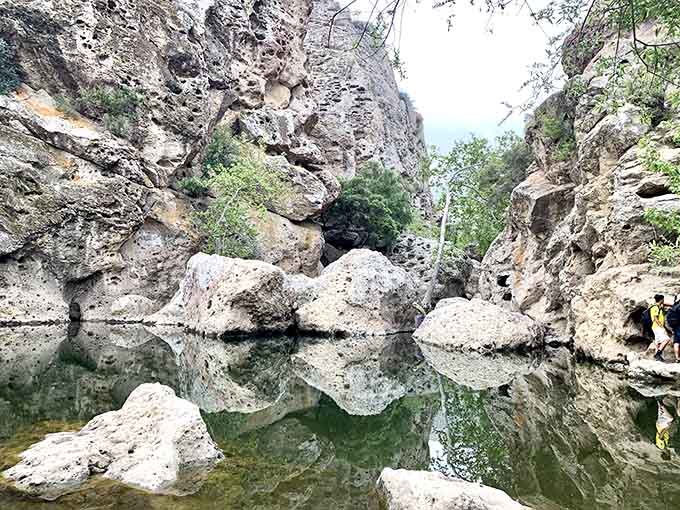 Nature's mirror trick: these ancient rocks create perfect reflections that'll have you doing double-takes all afternoon long.