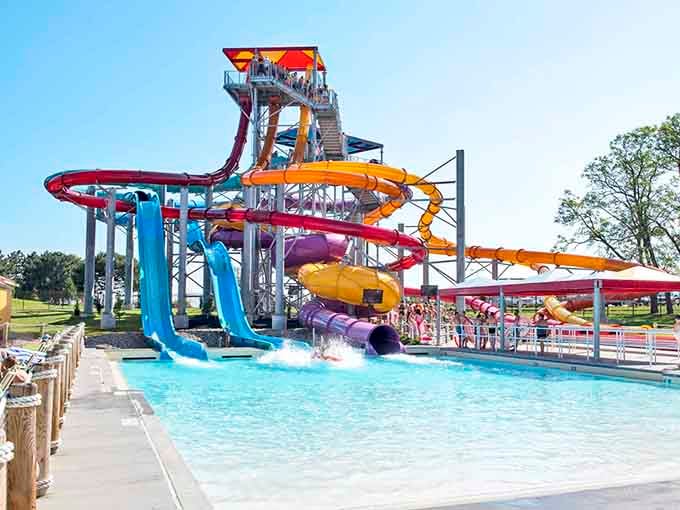 This rainbow tower of twisting slides looks like a giant box of crayons melted into pure summer joy.