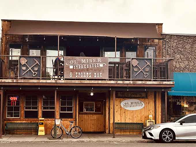 That weathered wood facade and second-story balcony whisper tales of mountain steaks and Old West hospitality.