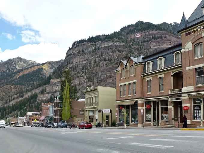 Victorian storefronts nestle beneath towering canyon walls that make you feel wonderfully, delightfully small in Ouray's embrace.
