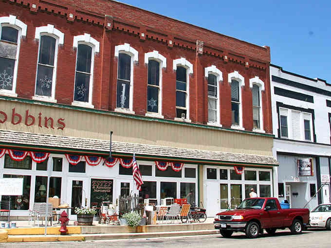 Red brick storefronts with patriotic bunting remind you that some Main Streets still know how to celebrate America properly.