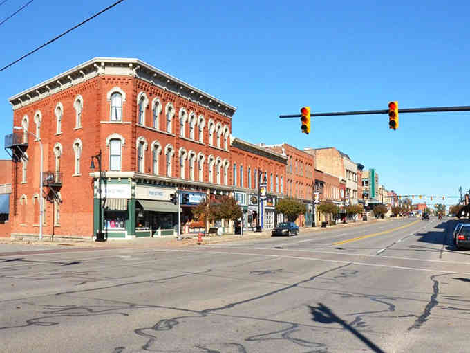 Classic brick storefronts line this downtown street where history meets everyday life in perfect harmony.