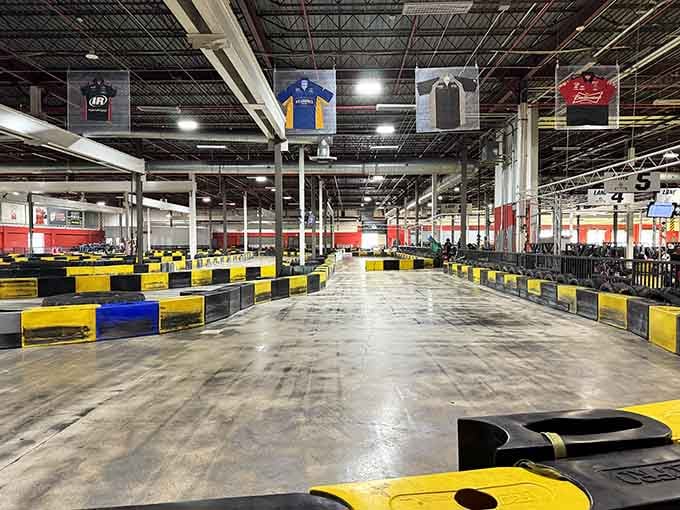 This sprawling indoor track stretches like a racing cathedral, with yellow barriers guiding your path to glory.