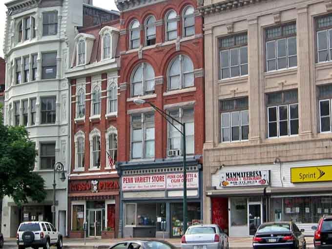 These historic storefronts wear their age like a badge of honor, standing proud with architectural details that smartphones can't replicate.