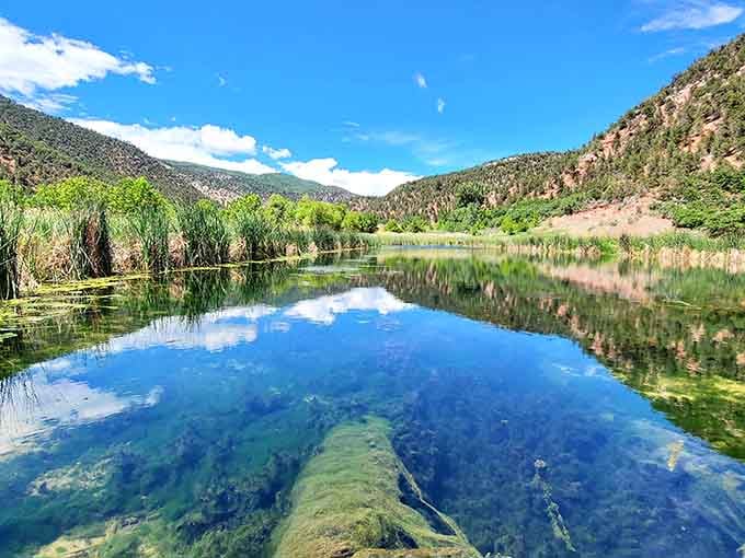 Mirror-perfect reflections turn this hidden canyon pool into nature's own kaleidoscope of emerald and sapphire blues.
