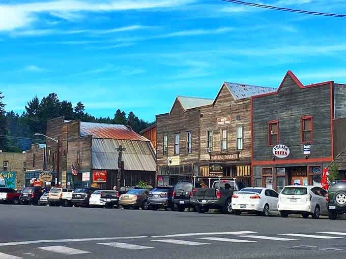 These weathered wooden storefronts stand like proud veterans, each telling stories from a century of mountain living.