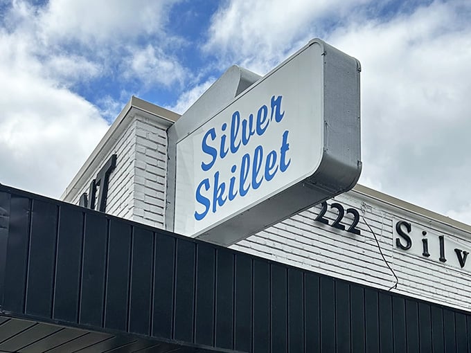 That classic script sign against blue sky tells you everything: this is where breakfast dreams come true daily.