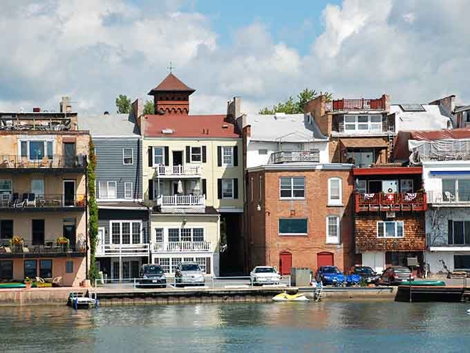 Waterfront living meets architectural charm where colorful homes stack like a perfectly arranged box of crayons along the shore.