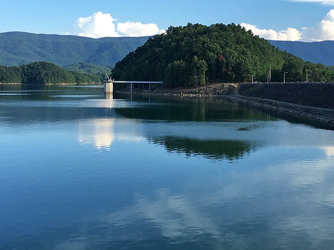 Mountains reflected in glass-smooth water create a scene so perfect it looks like nature's own screensaver.