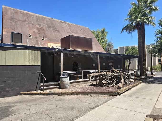 That rustic covered patio and old wagon wheel tell you everything: this place values flavor over fancy decorations.
