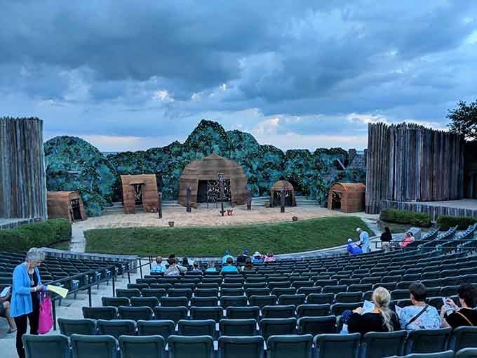 An open-air theater where history comes alive as evening begins to settle in, set against weathered wood and coastal mystery.