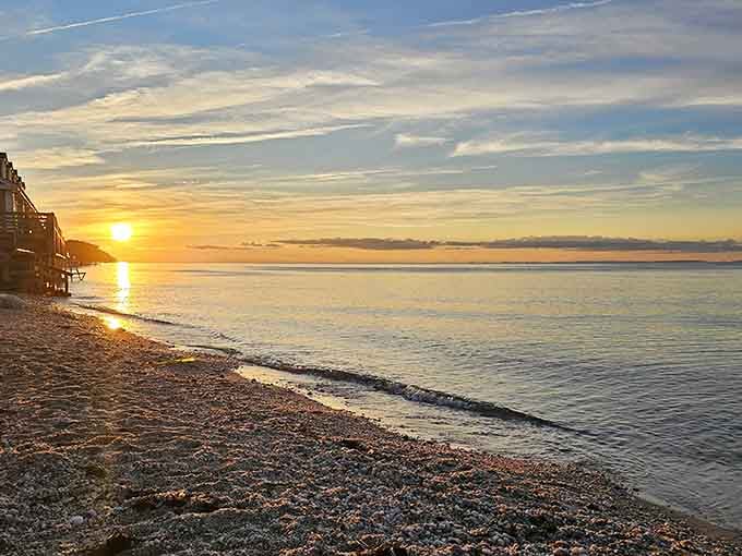 Golden hour transforms this pebbly shoreline into something that belongs on a postcard you'd actually want to send.