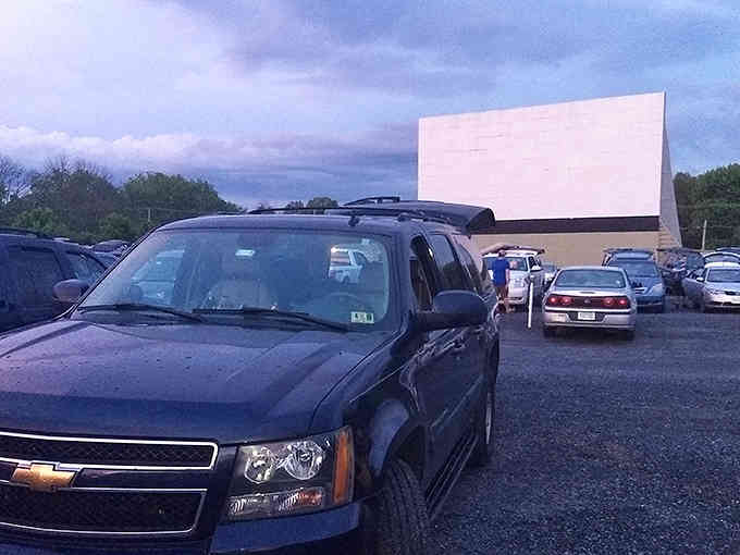 That towering screen against the twilight sky is your invitation to movie magic, old-school style.