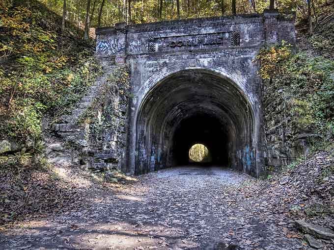 That first glimpse through the trees hits different when you realize this tunnel has been collecting ghost stories for over a century.