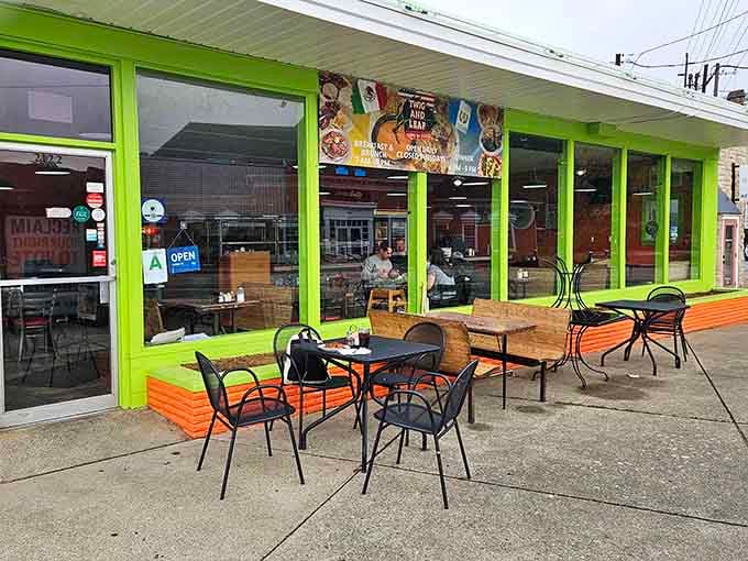 The vibrant storefront draws neighbors and visitors alike, where orange benches invite leisurely meals on Bardstown Road.