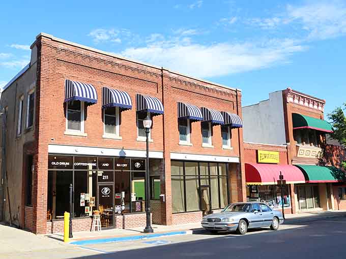 Those striped awnings and brick storefronts prove small-town charm never goes out of style, like a classic sedan.