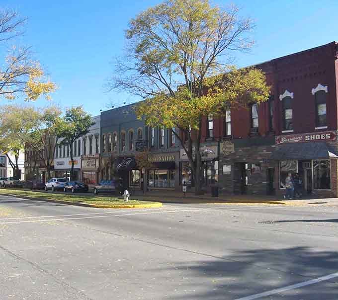 Classic storefronts line up like old friends catching up over coffee on this tree-shaded boulevard.